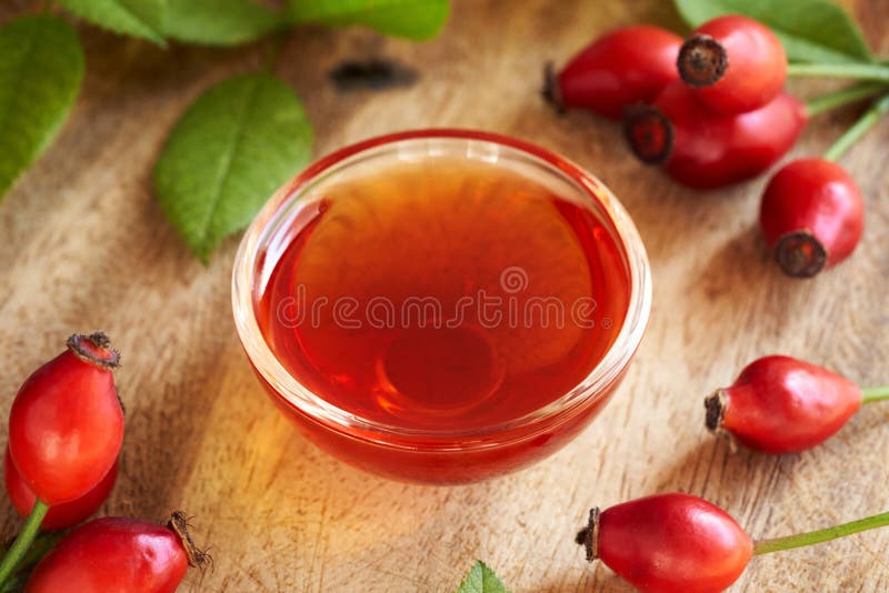 A Bowl of Rosehip Seed Oil with Fresh Rose Hips Stock Image - Image of ...
