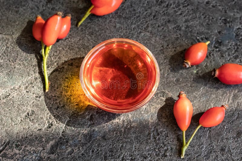A Bowl of Rosehip Seed Oil with Fresh Rosehips Stock Image - Image of ...