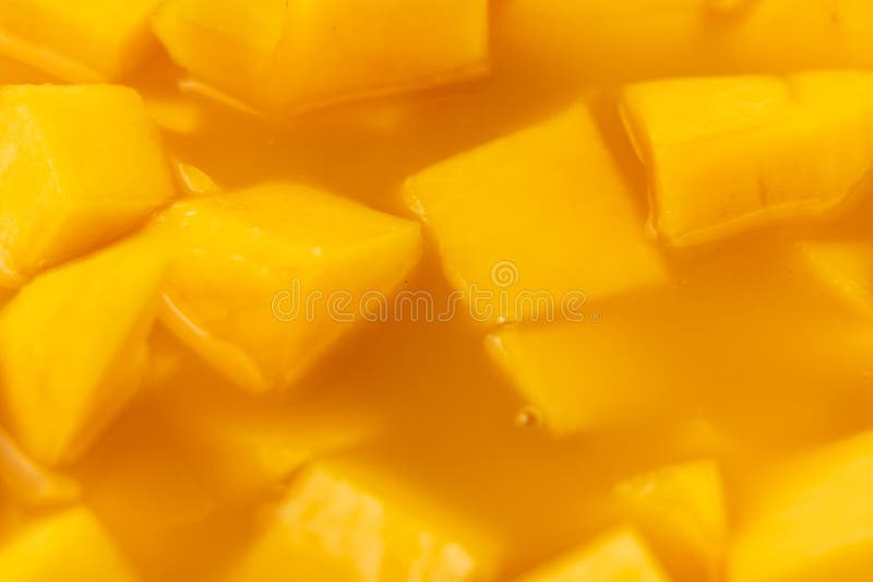 A Bowl of Sliced Mangoes in a Yellow Liquid Stock Image - Image of ...