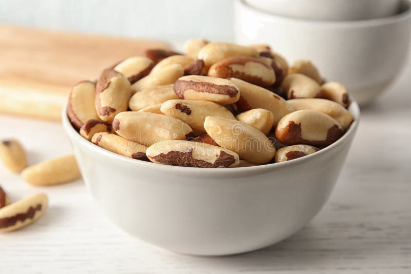 Bowl with Tasty Brazil Nuts on White Stock Photo - Image of delicacy ...