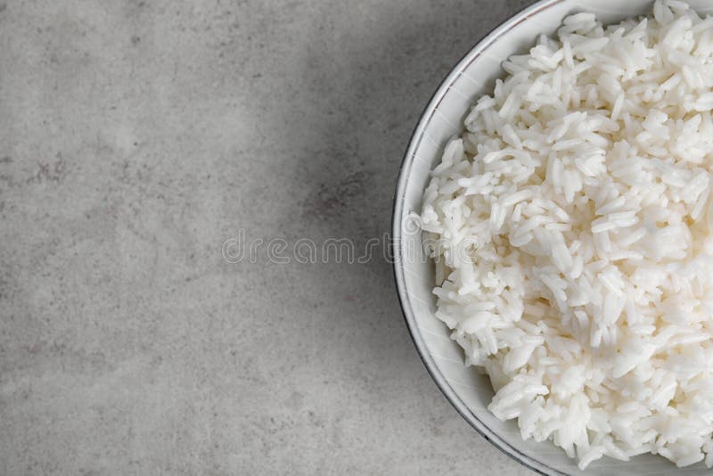 Bowl with Tasty Cooked Rice on Light Table, Top View. Space for Text ...