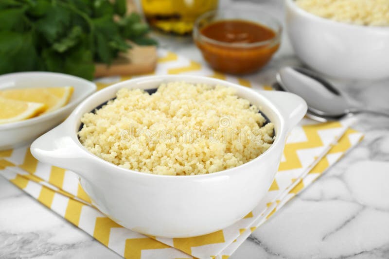 Bowl of Tasty Couscous on White Marble Table, Closeup Stock Image ...