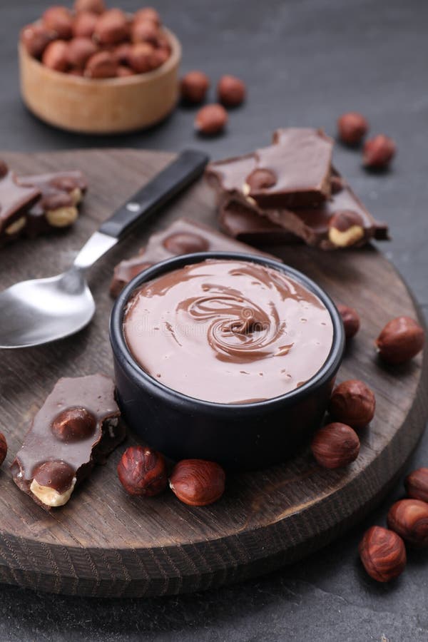 Bowl with Tasty Paste, Chocolate Pieces and Nuts on Grey Table Stock ...