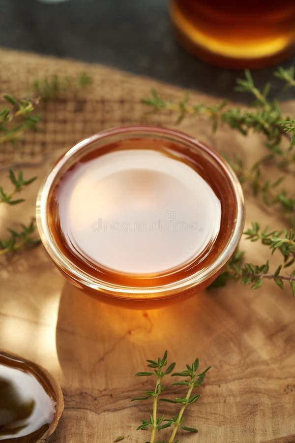 A Bowl of Thyme Syrup on a Table Stock Image - Image of leaf ...