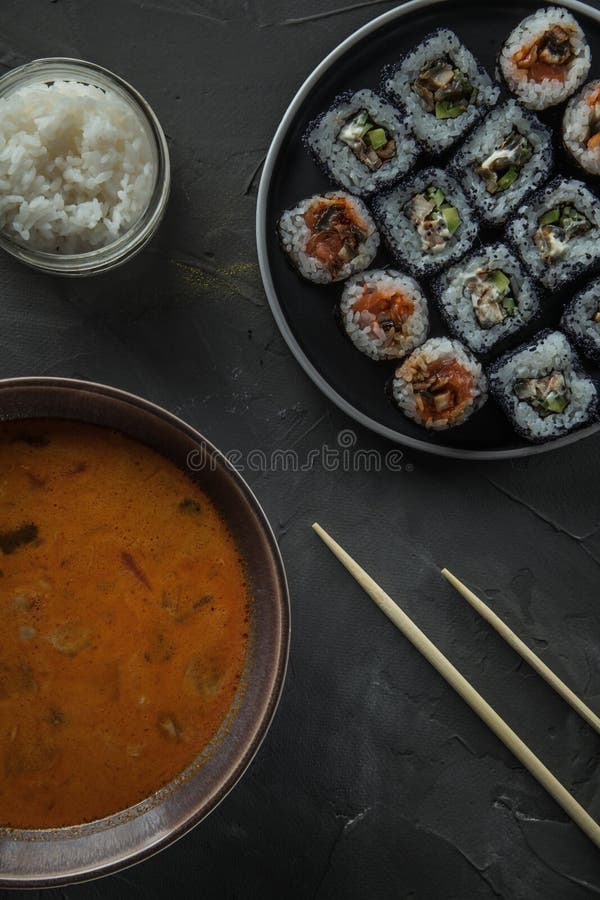 A Bowl of Tom Yam Soup, a Jar of Rice and a Set of Sushi. Top View ...