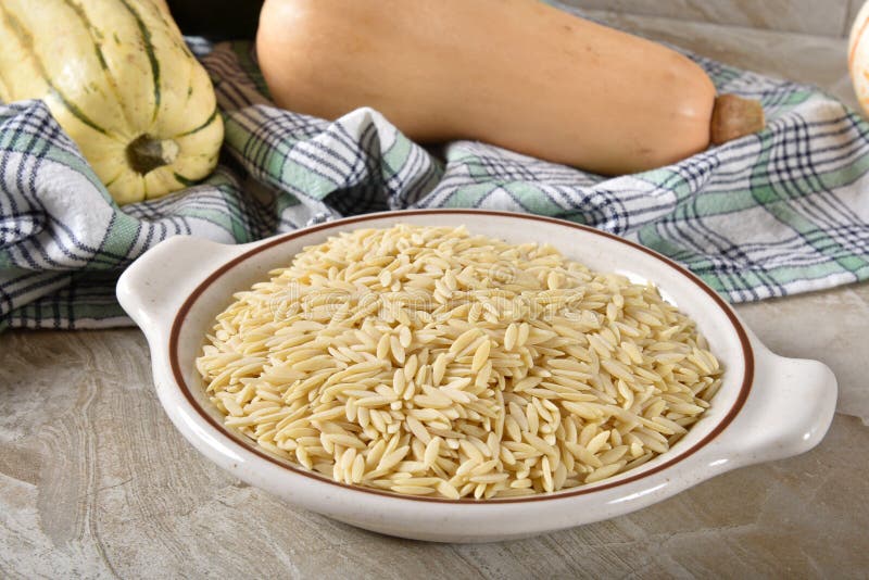 Bowl of uncooked orzo stock photo. Image of healthy - 131037674