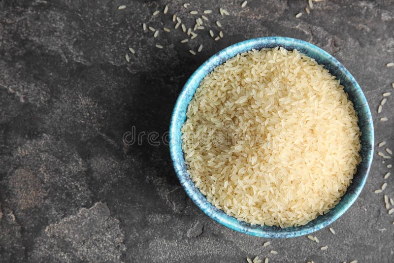 Bowl with Uncooked Rice on Grey Background, Top View. Stock Photo ...
