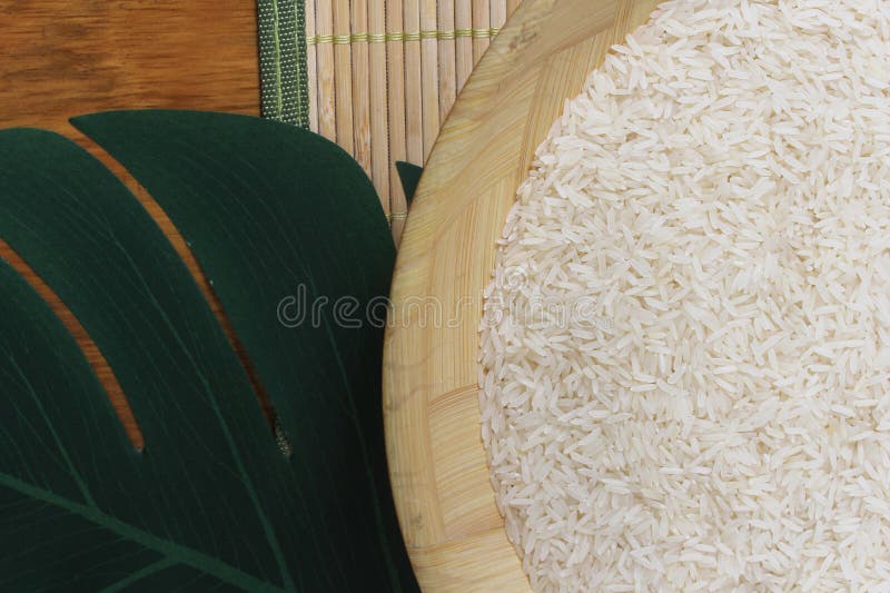 Bowl of Uncooked White Rice with Leaf and Bamboo Mat Stock Image ...