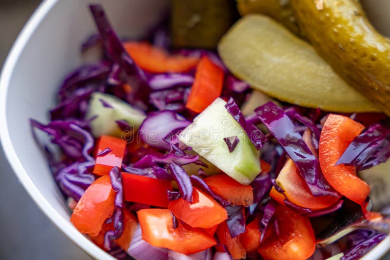 A Bowl of Vegetables with a Pickle on Top Stock Photo - Image of purple ...
