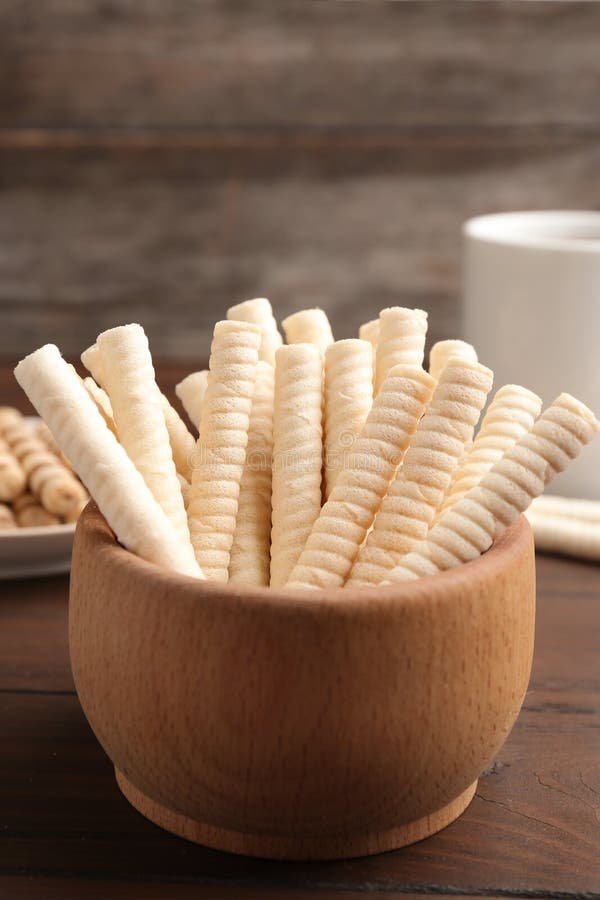 Bowl with Wafer Rolls on Wooden Table Stock Photo - Image of culinary ...