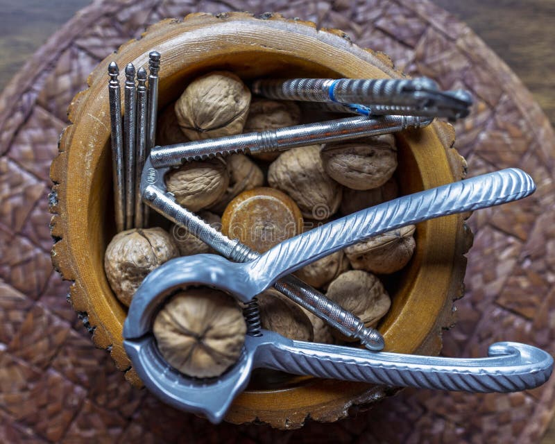 A Bowl of Walnuts Still in the Shell in a Bowl with Several Tools for ...