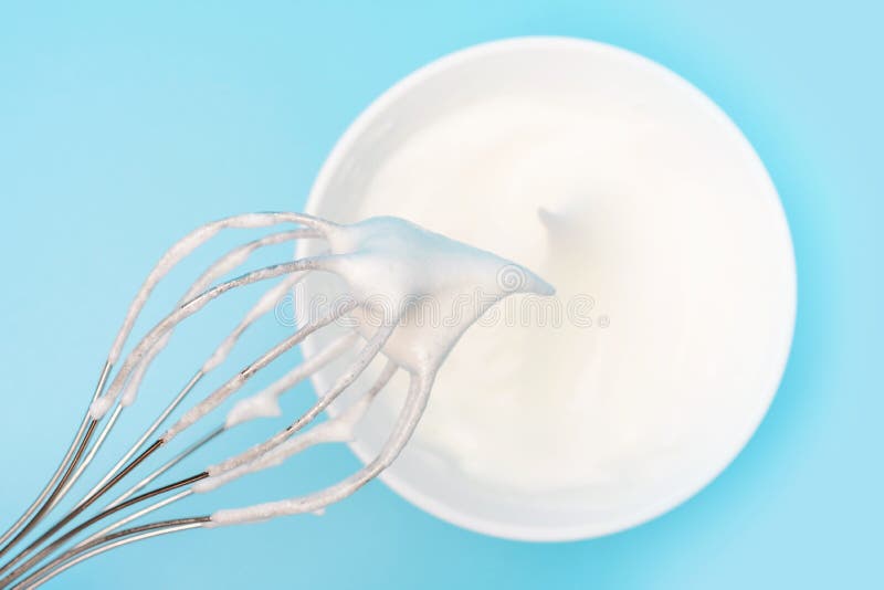 Bowl with Whipped Protein Cream and Whisk on Blue Background Top View ...