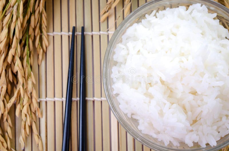 Bowl of White Steamed Rice with Chopsticks on Bamboo Mat. Stock Image ...