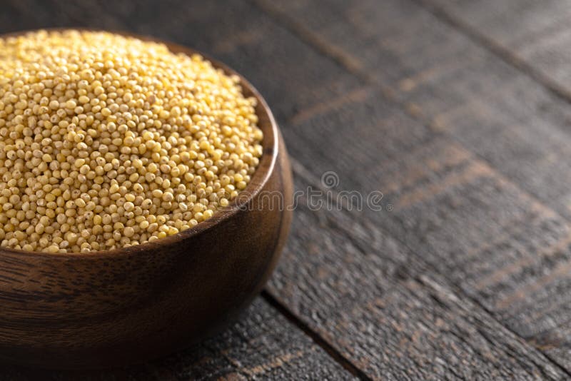Bowl of Whole Millet in a Wood Bowl on a Rustic Dark Wood Table Stock ...