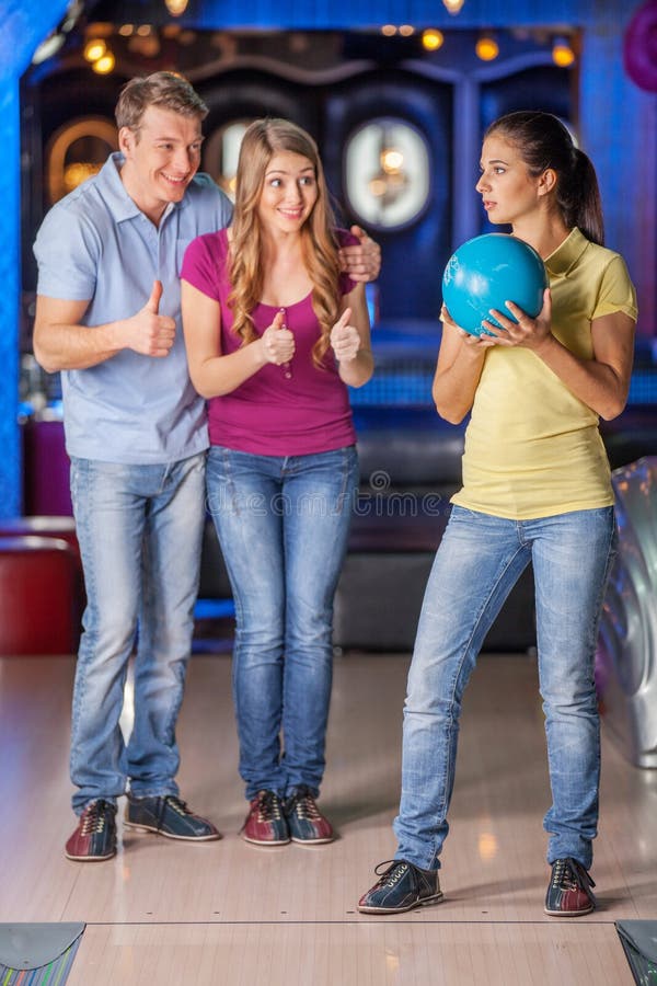 Family in Bowling Alley with Two Friends Smiling Stock Photo - Image of ...