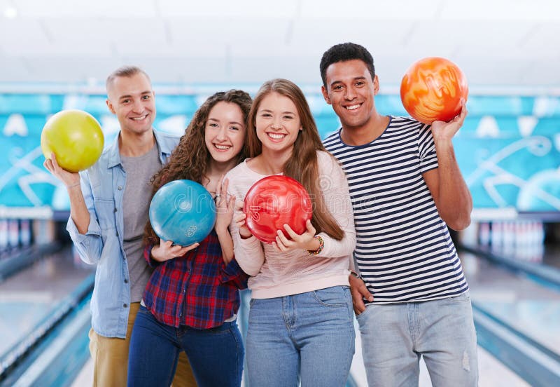 Family in Bowling Alley with Two Friends Smiling Stock Photo - Image of ...