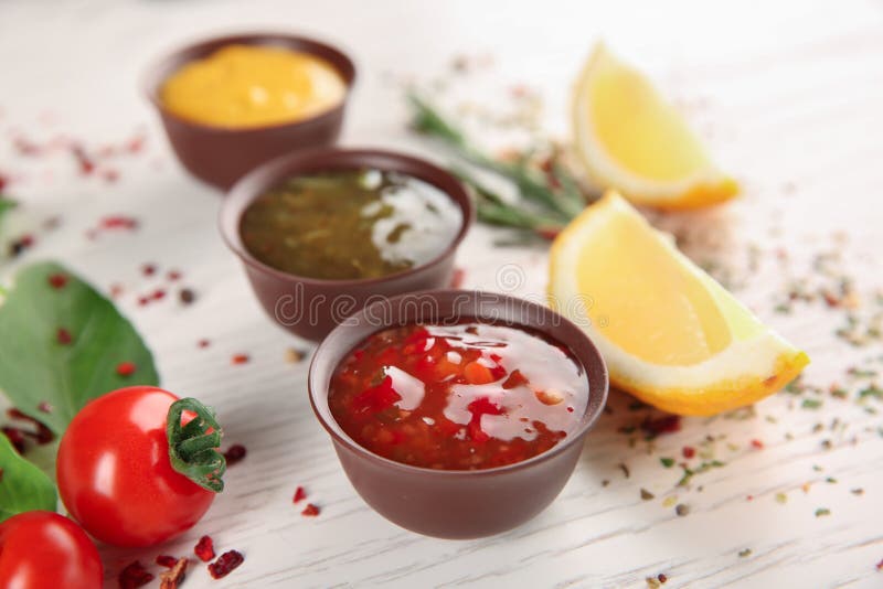 Bowls with Different Sauces and Ingredients on Light Background Stock ...