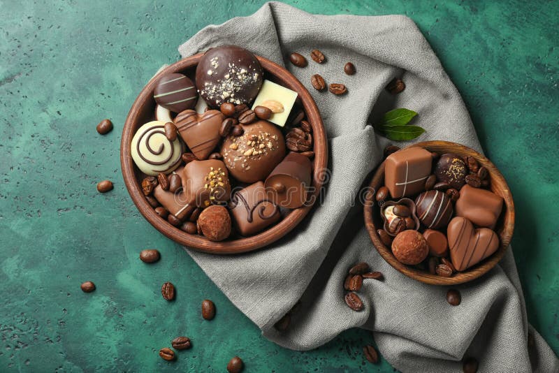 Bowls with Different Tasty Chocolate Candies on Textured Table Stock ...