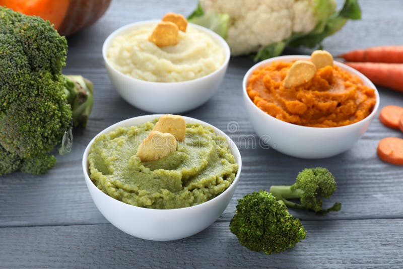 Bowls with Different Tasty Puree and Ingredients on Light Blue Table ...