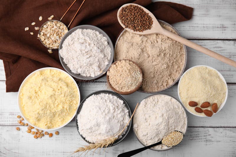 Bowls with Different Types of Flour and Ingredients on White Wooden ...