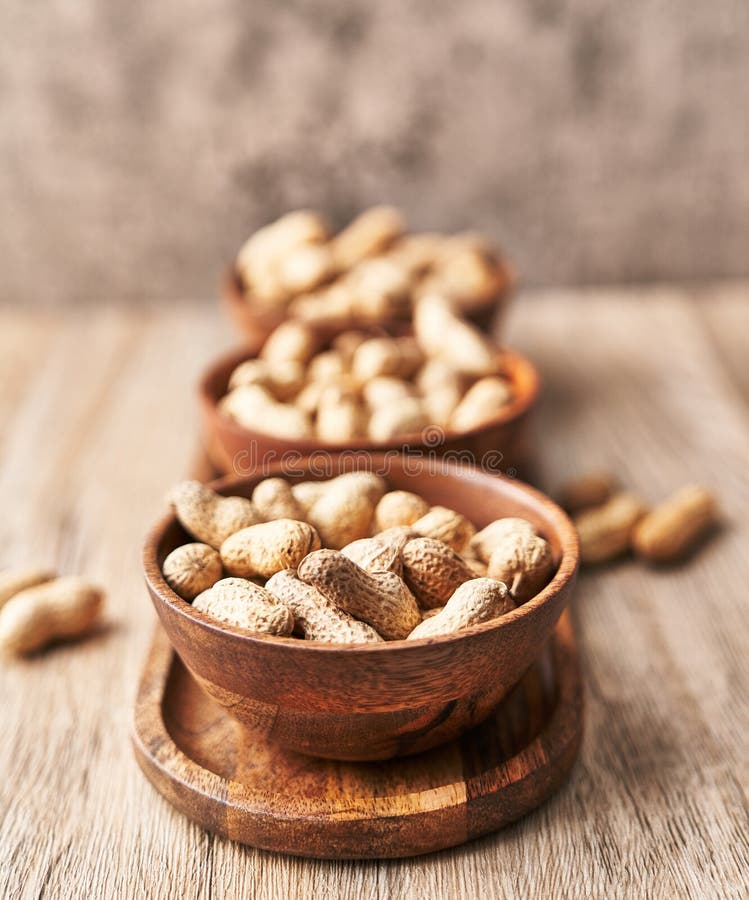 Bowls of Peanuts with Shell on a Wooden Surface Stock Photo - Image of ...