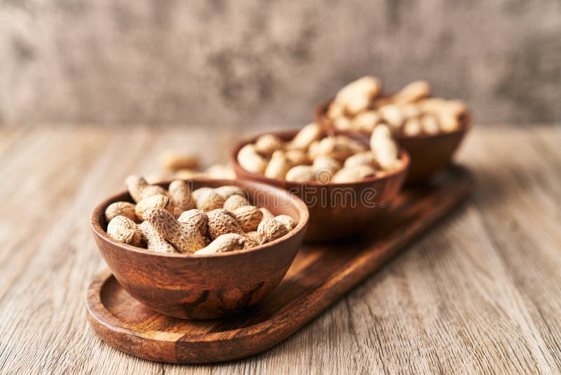 Bowls of Peanuts with Shell on a Wooden Surface Stock Photo - Image of ...