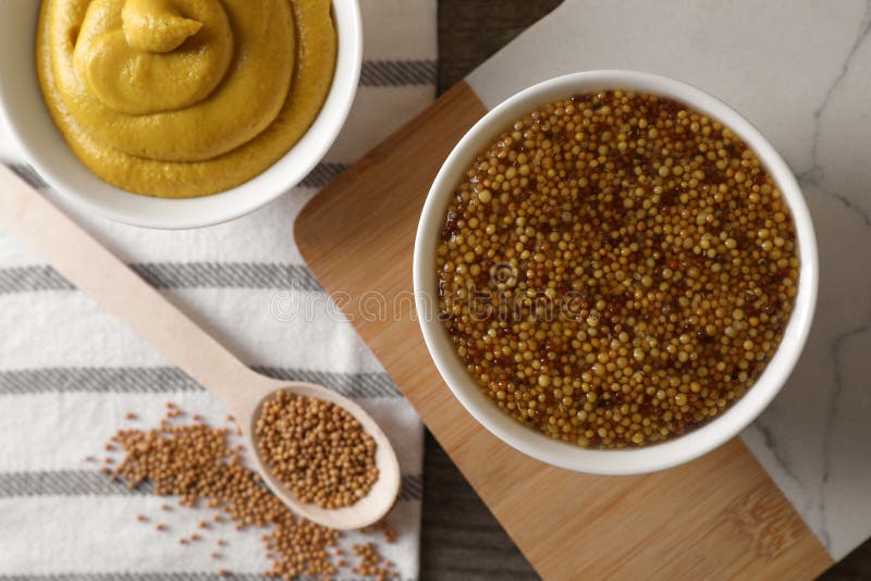 Bowls and Spoon of Whole Grain Mustard on Wooden Table, Flat Lay Stock ...