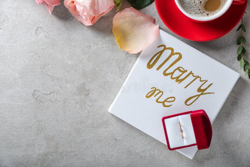 Box with Beautiful Engagement Ring and Roses on Grey Table Stock Photo ...