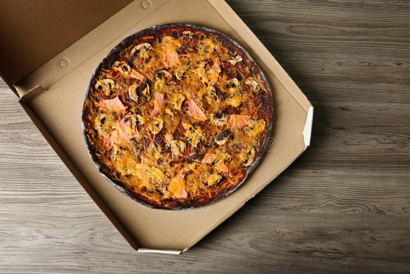 Black Pizza with Seafood on a Wooden Round Plate on a White Stock Image ...