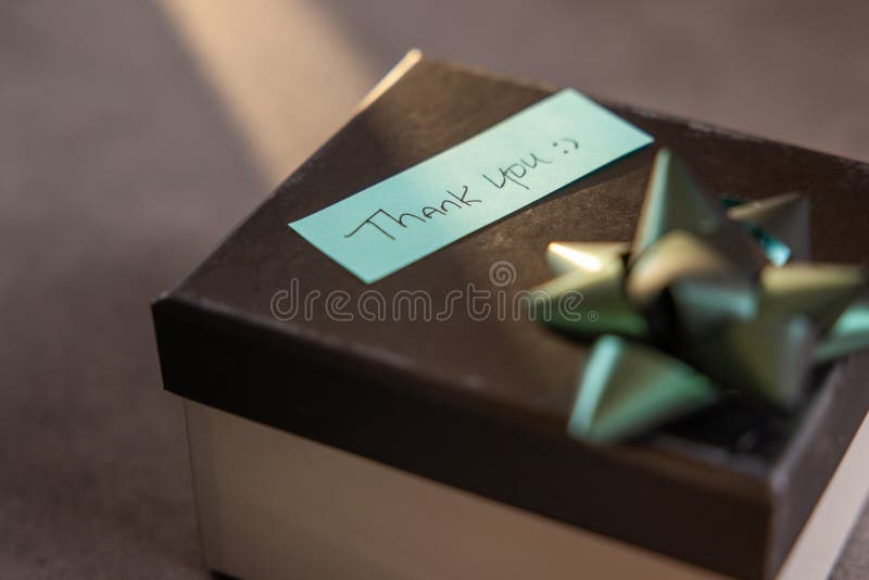 A Box with a Bow on Top and a Note that Says "Thank You" Written on it ...