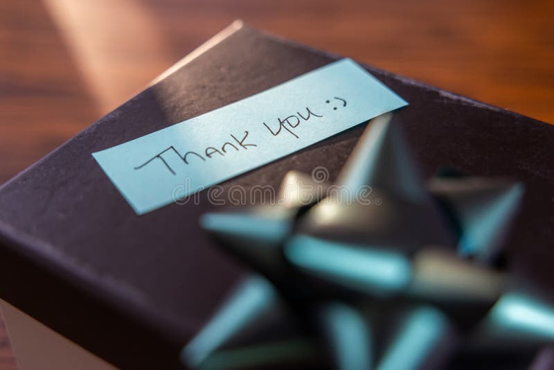A Box with a Bow on Top and a Note that Says "Thank You" Written on it ...