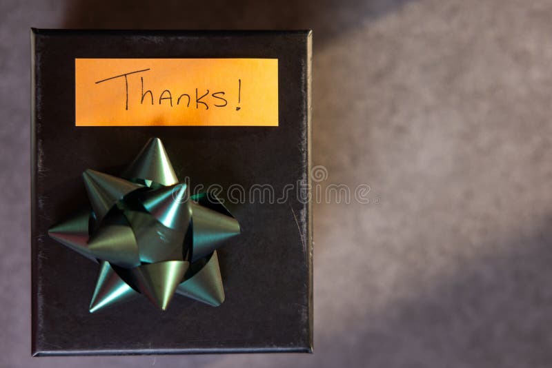 A Box with a Bow on Top and a Note that Says "Thanks" Written on it ...