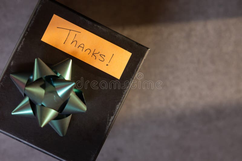 A Box with a Bow on Top and a Note that Says "Thanks" Written on it ...