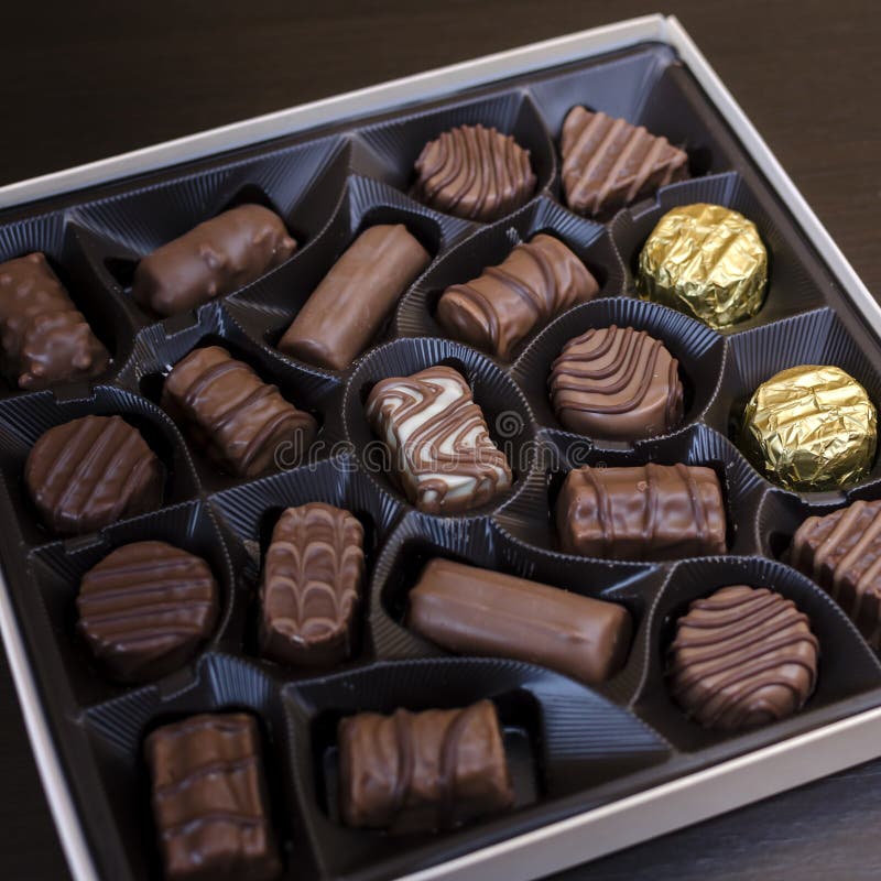Box of chocolates on table stock image. Image of variety - 139380721