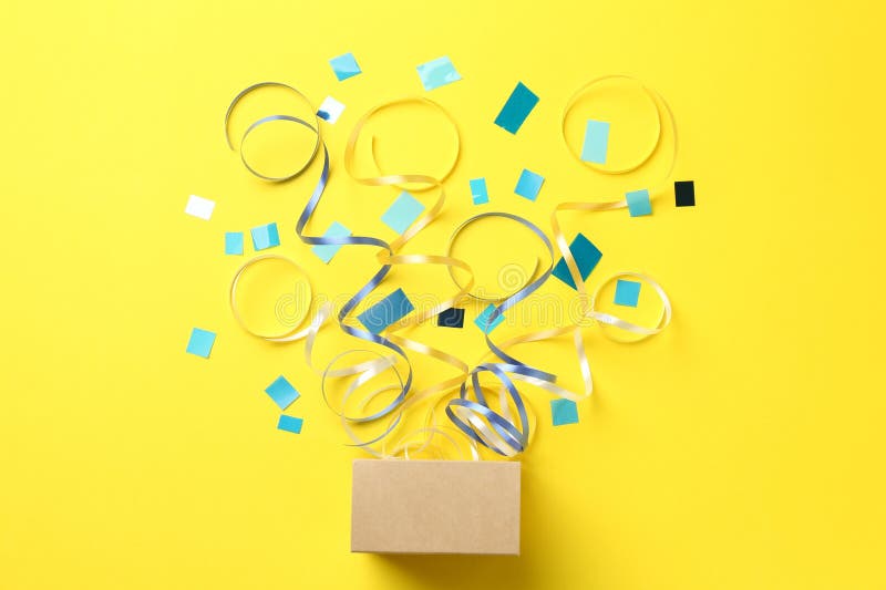 Box with Confetti and Party Streamers on Yellow Background, Flat Lay ...