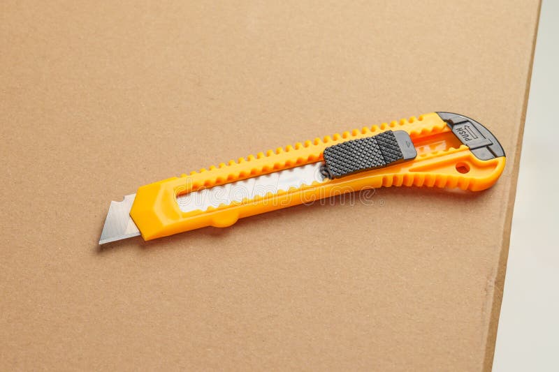 Box Cutter on a Parcel Cardboard Box. Retractable Utility Knife Stock ...