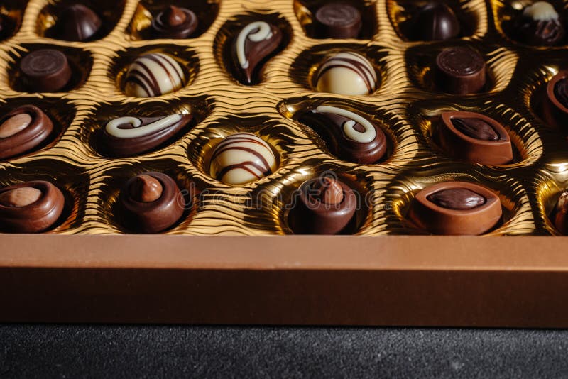 A Box of Different Chocolates. Chocolate Assortment Mix on the Black ...