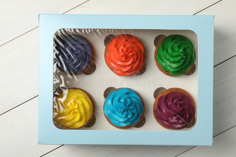 Box with Different Cupcakes on White Wooden Table, Top View Stock Photo ...