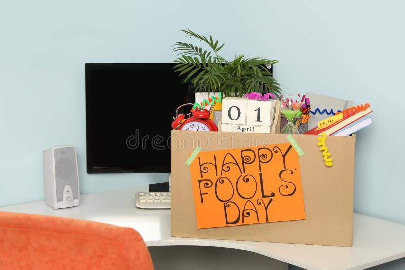 Box with Different Items and Words Happy Fool`s Day at Workplace in ...