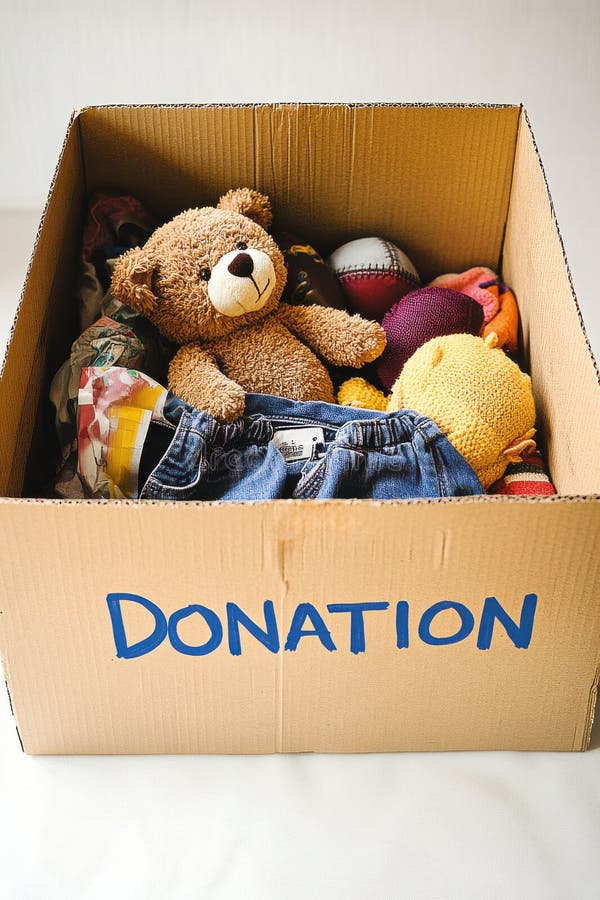 A Box of Donated Items Including a Teddy Bear and a Football Stock ...