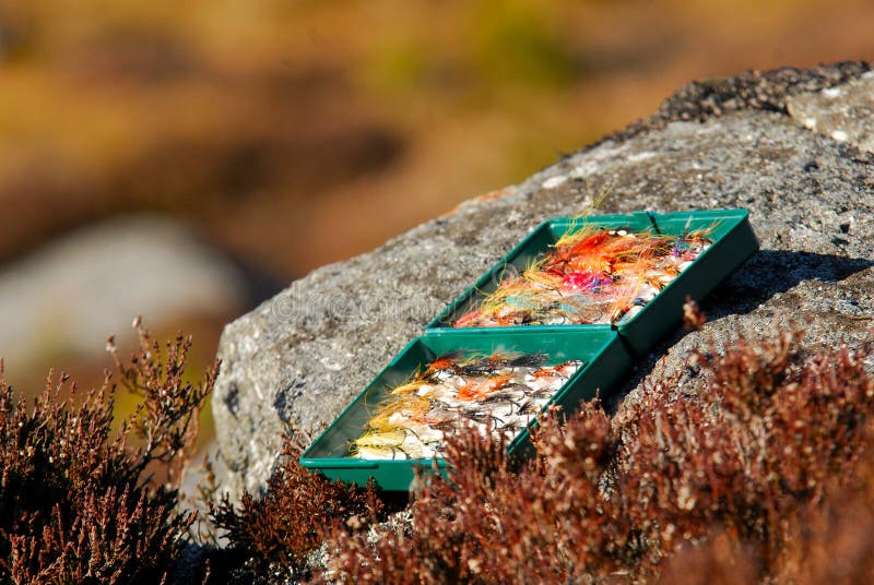 Fishing Tackle Box of Fly Fishing Flies on a Riverbank Rock Stock Photo ...