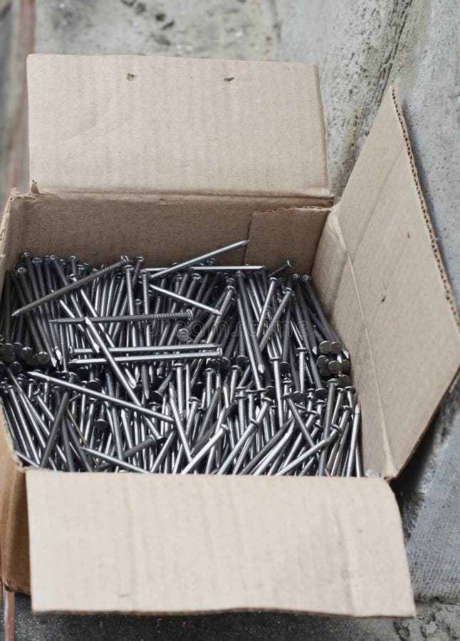 A Box Full of Long Metal Building Nails for a House Construction Stock ...