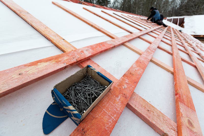 The Box with Nails on the Roof and Roofer Working on Roof Structure of ...