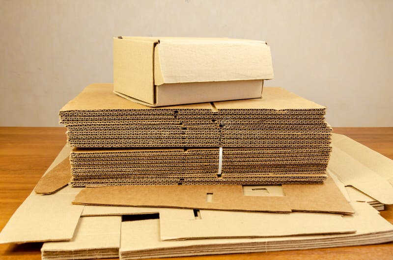 Box Ready for Product Packaging and a Stack of Folded Corrugated ...