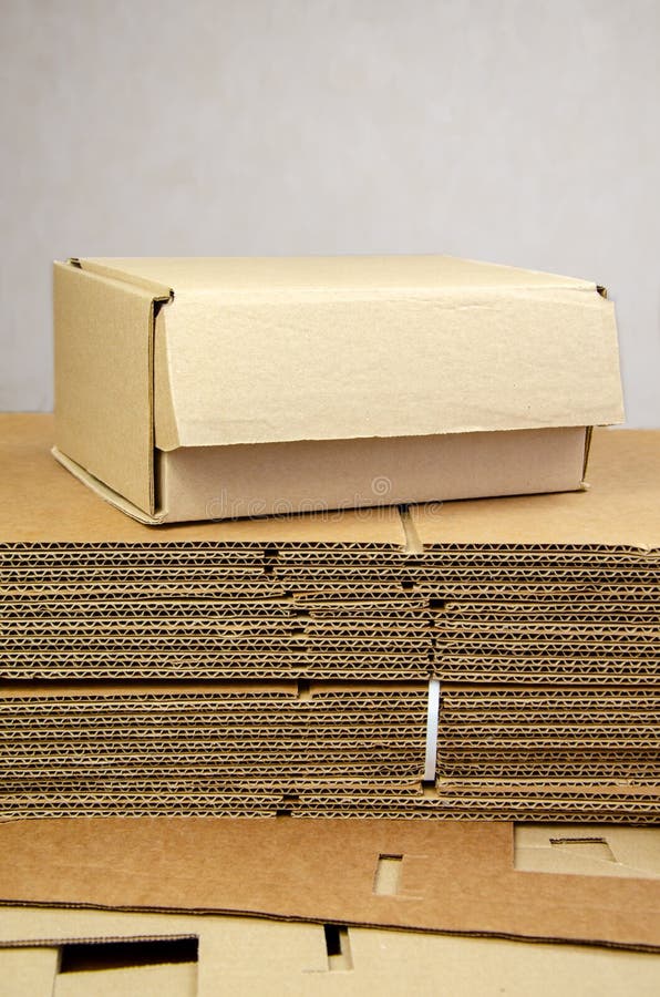 Box Ready for Product Packaging and a Stack of Folded Corrugated ...