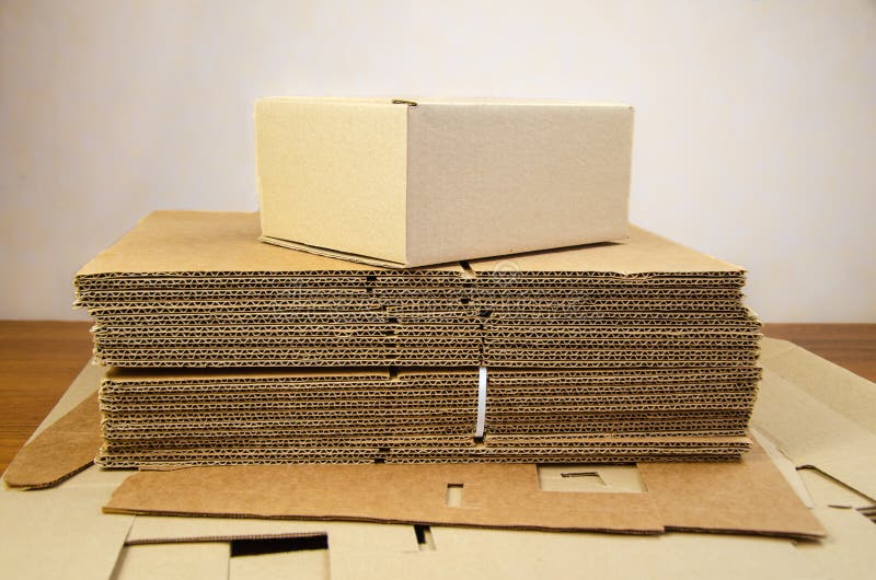 Box Ready for Product Packaging and a Stack of Folded Corrugated ...