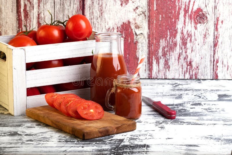 Box with Ripe Tomatoes and Tomato Juice in a Glass Bottle Stock Photo ...