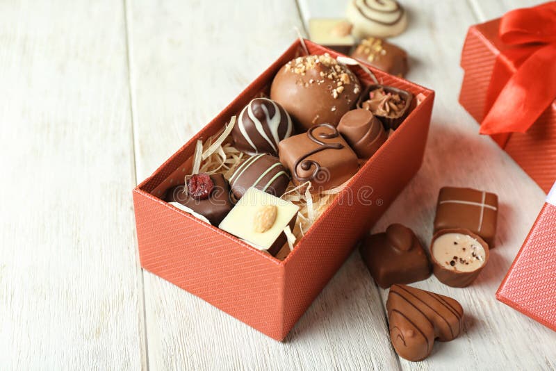 Box with Tasty Chocolate Candies on Wooden Table Stock Photo - Image of ...