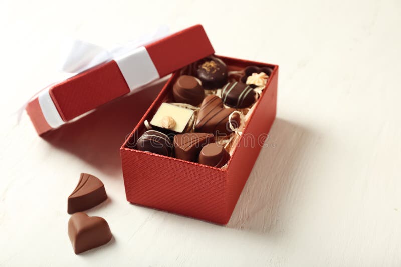 Box with Tasty Chocolate Candies on Wooden Table Stock Image - Image of ...