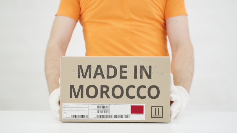 Carton with MADE in MOROCCO Text Being Placed on the Table Stock ...